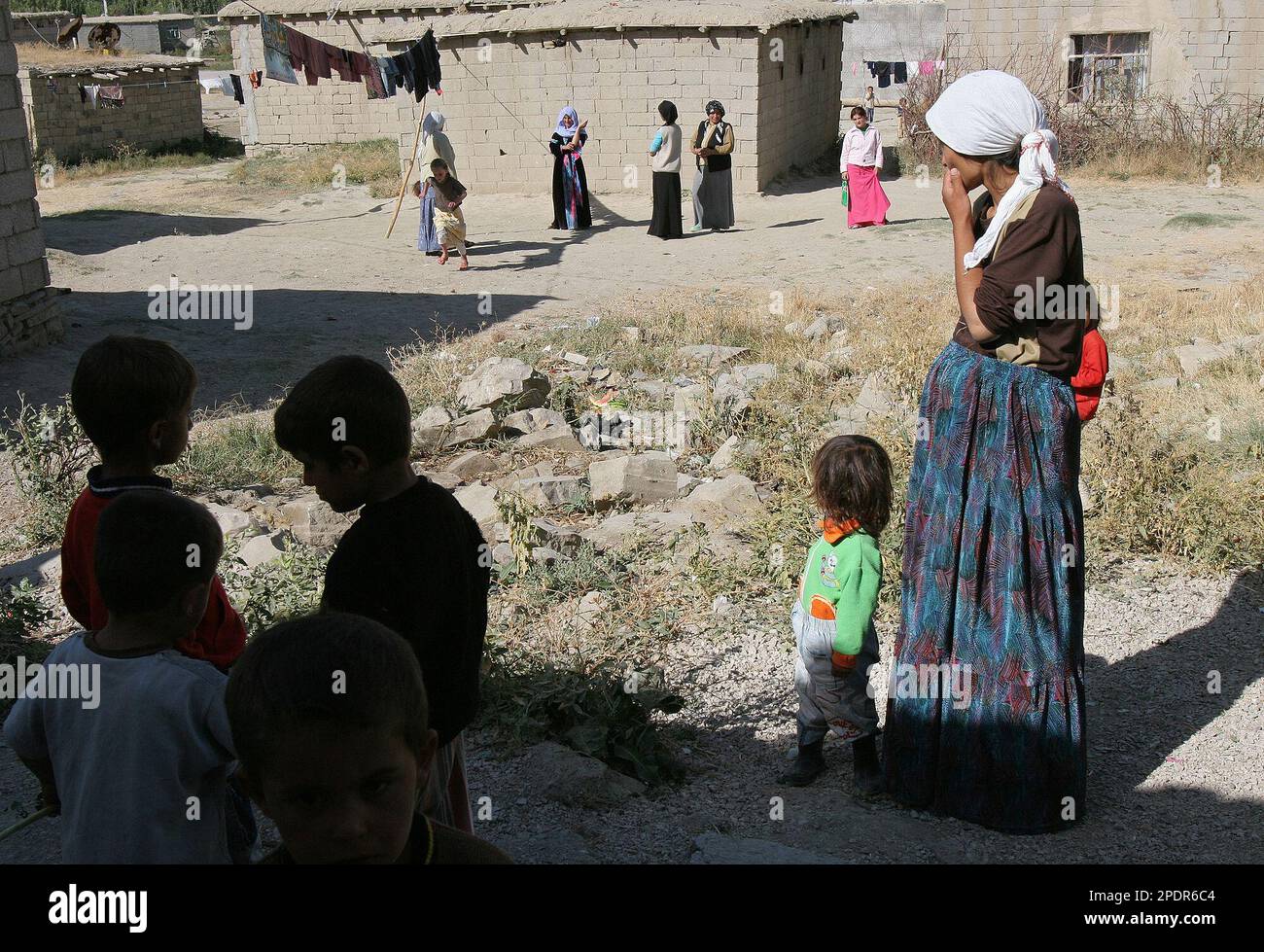 Mothers with their children in a slum area in the eastern Turkish city ...