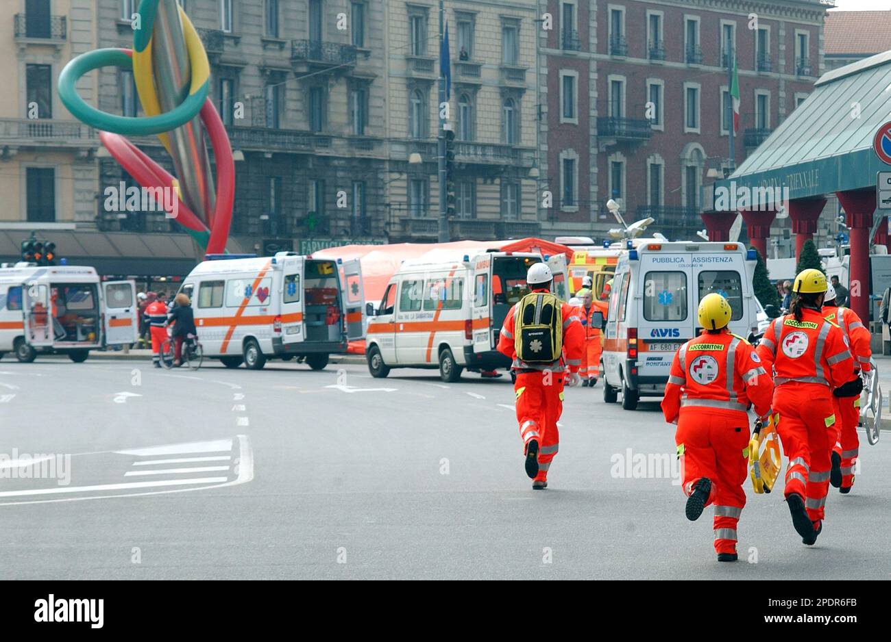 Rescue crew give first aid to injured people at the train station of ...