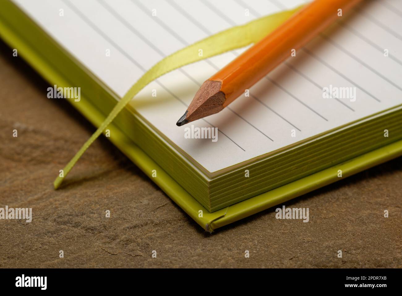 A lined notebook with a pencil. Ready to take notes, sketch ideas and ...