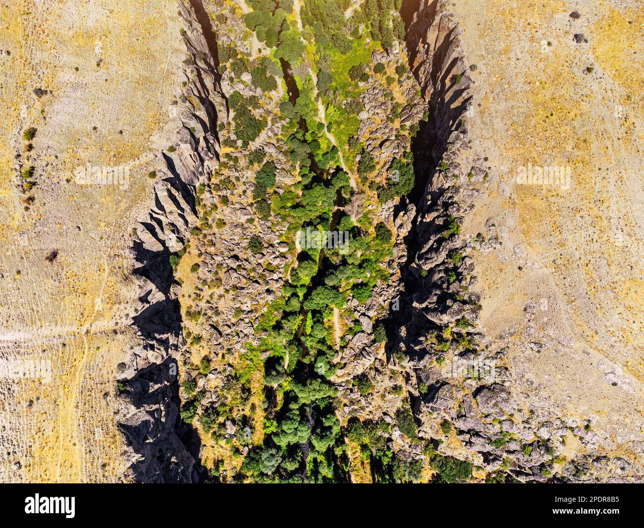 Aerial view of a deep gorge and steep cliffs with dark river Stock ...