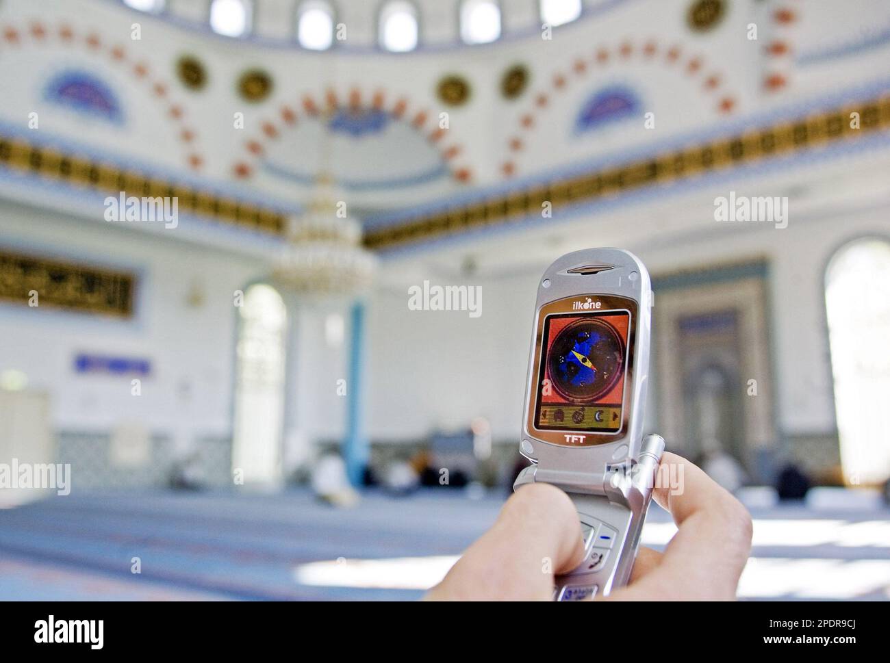 A lightweight IIkone i800 cellular telephone is shown in front of ...