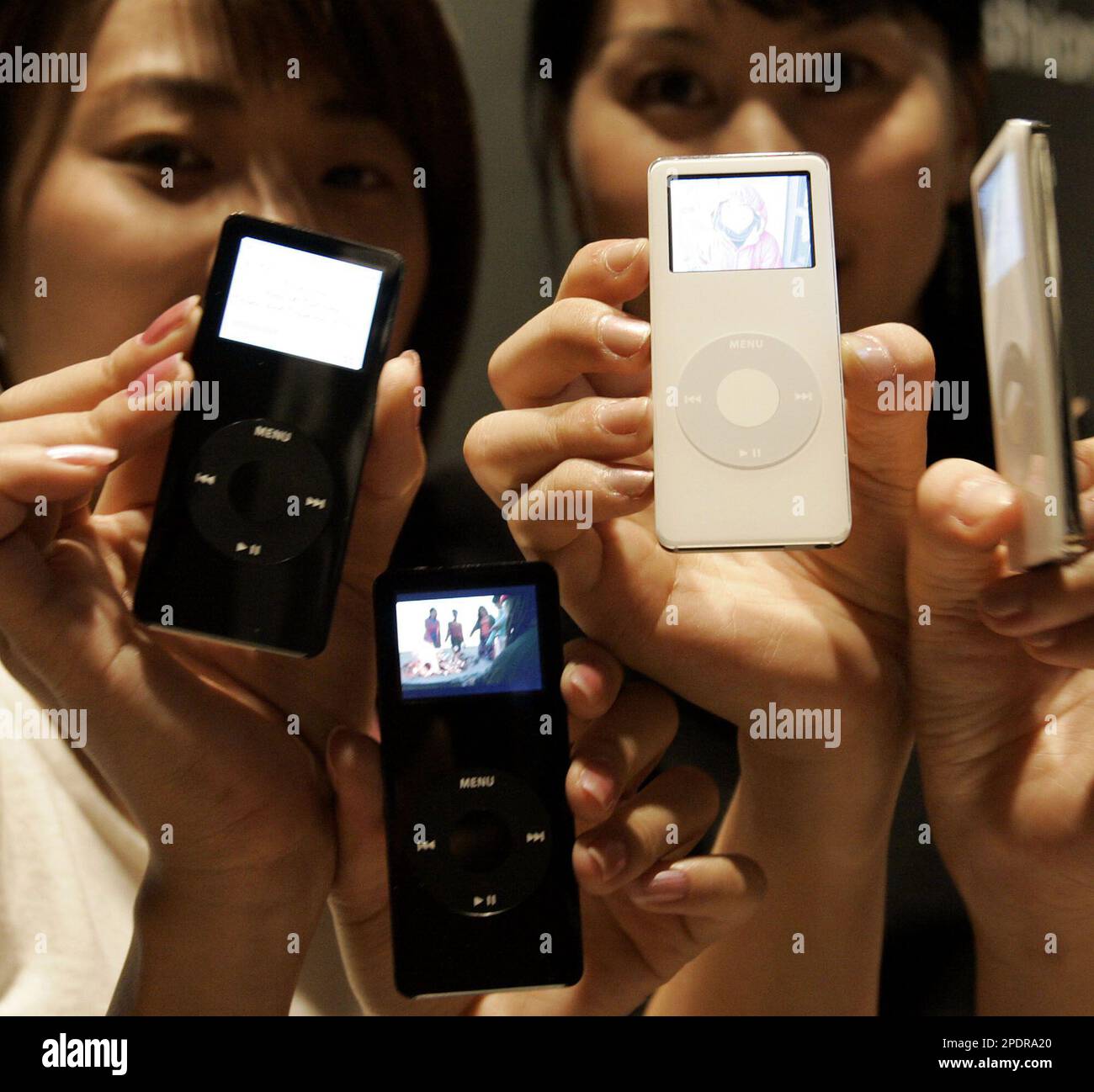 South Korean models hold up new thin Apple iPod Nano showing a front ...