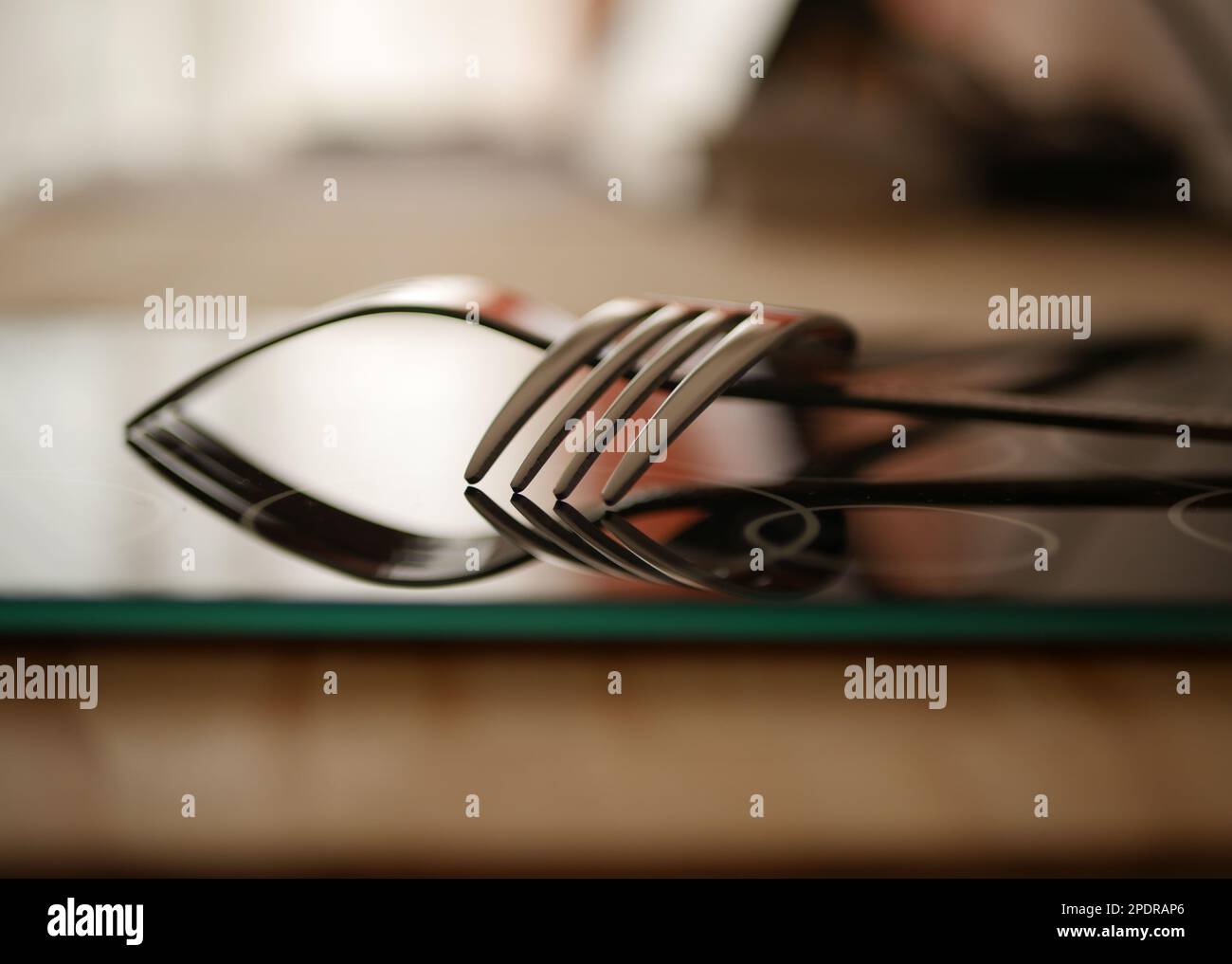 Forks on the table with a sweety light Stock Photo - Alamy