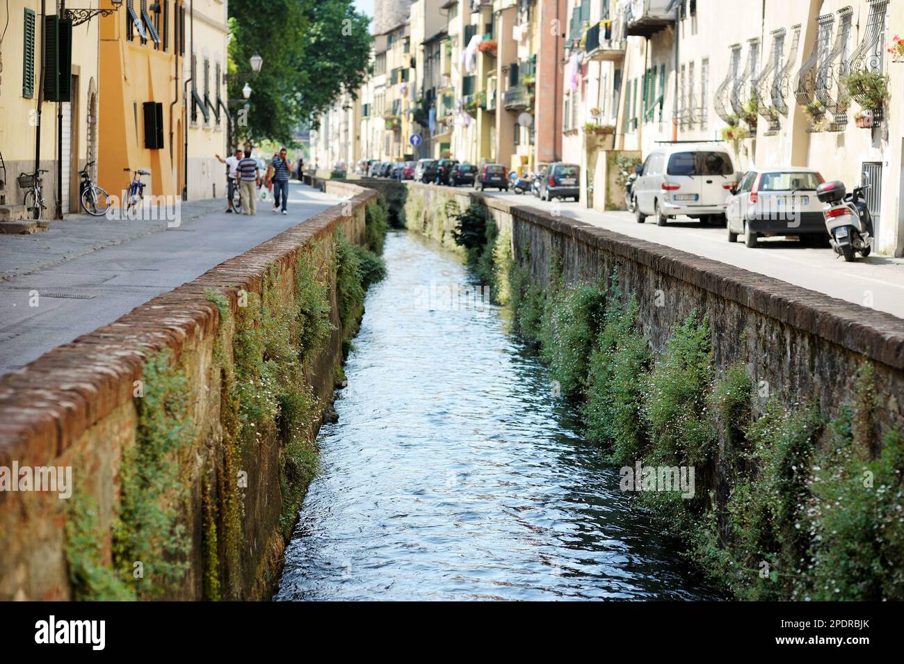 LUCCA, ITALY - MAY 2011: Walled stream running down the centre of Lucca ...