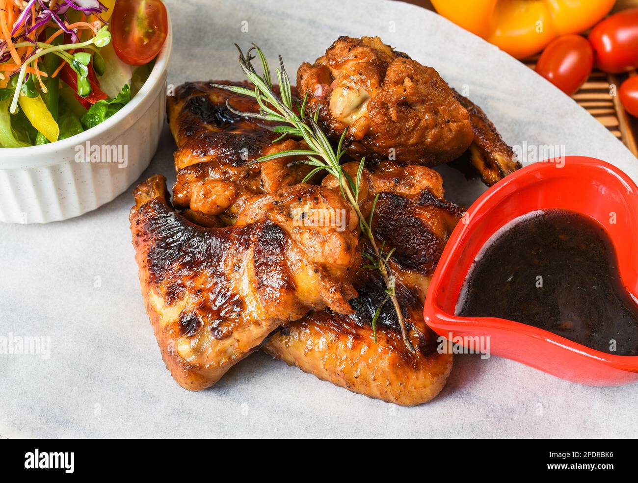 Fried chicken wings served vegetable sauce and sauce on white plate ...