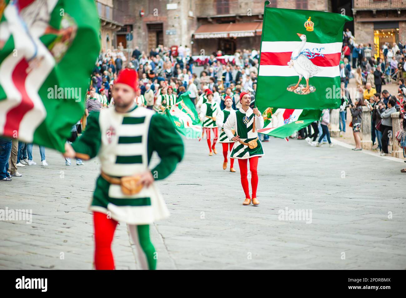 SIENA, ITALY - JULY 2013: Members of the noble Contrada dell'Oca ...