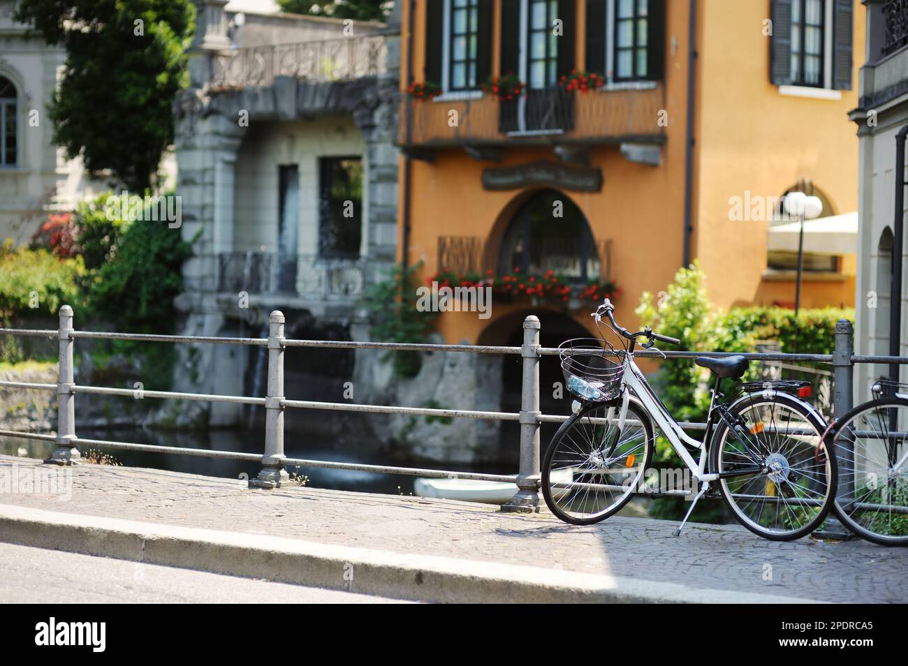 Bicycle parked on old cobblestone street with souvenir shops ...