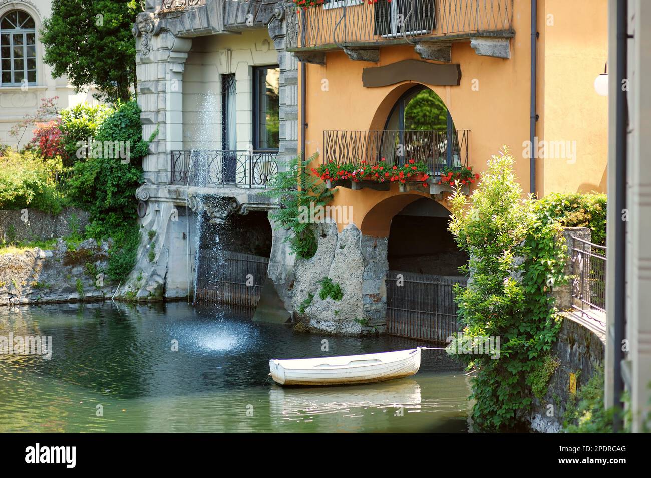 Boat docked near old medieval house in Como town, Lake Como, Italy ...