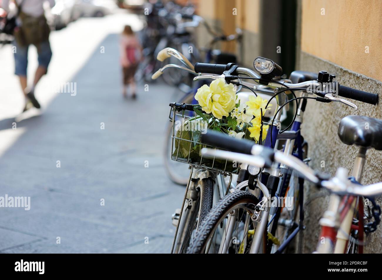 Bicycles parked on beautiful medieval streets of Lucca city, known for ...