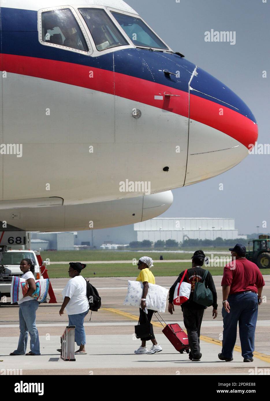 Hurricane Katrina refugees board a plane bound for Arkansas Tuesday ...