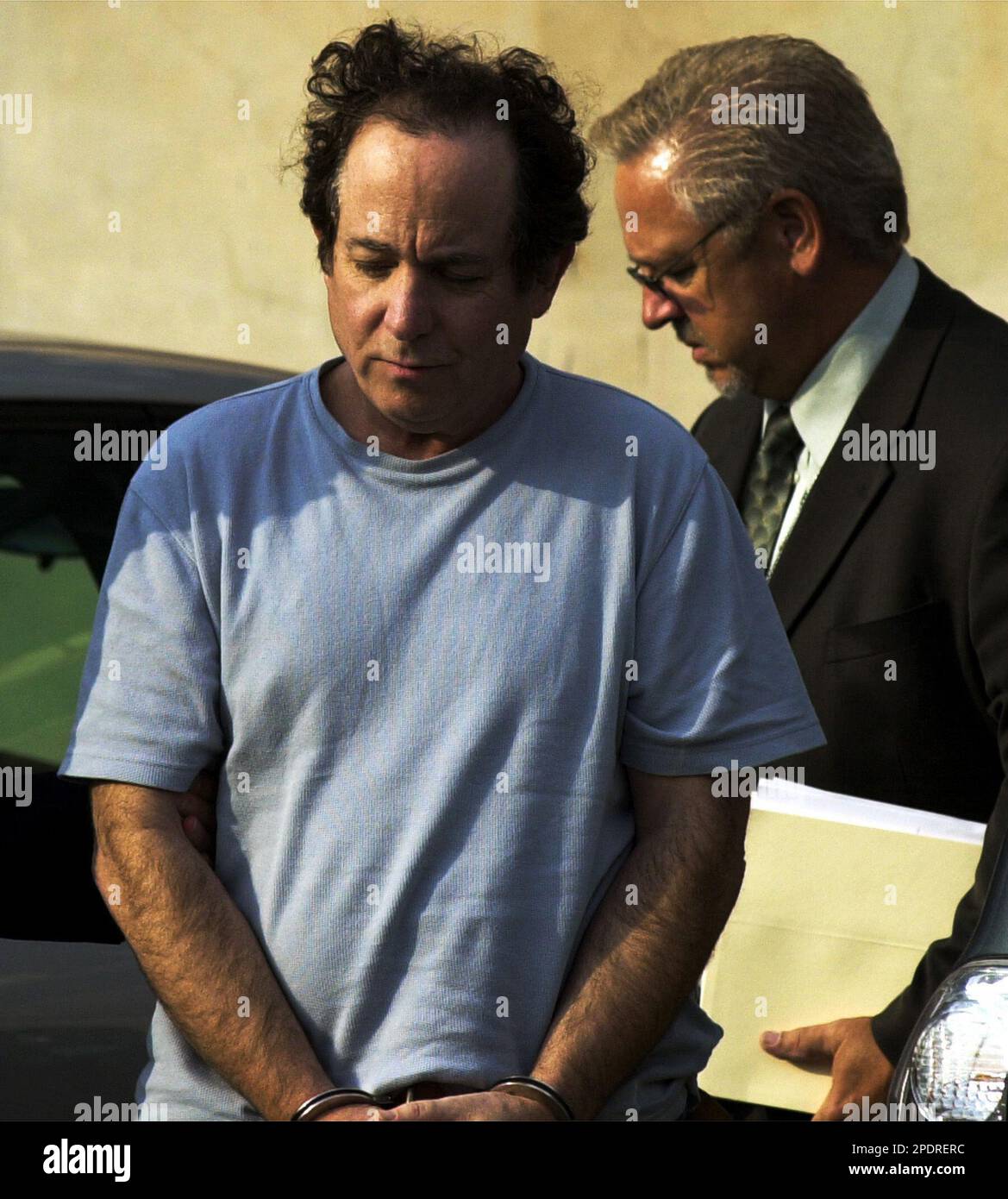 Mark David Frankel, left, is led into a district judge's courtroom in ...