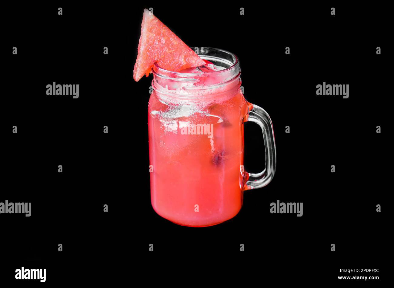 Glass of fresh watermelon juice with ice isolated on black background ...