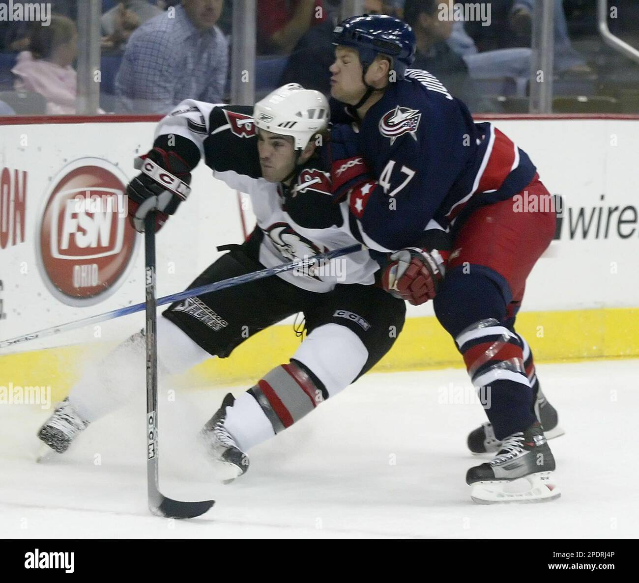 Columbus Blue Jackets' Aaron Johnson, right, checks Buffalo Sabres ...