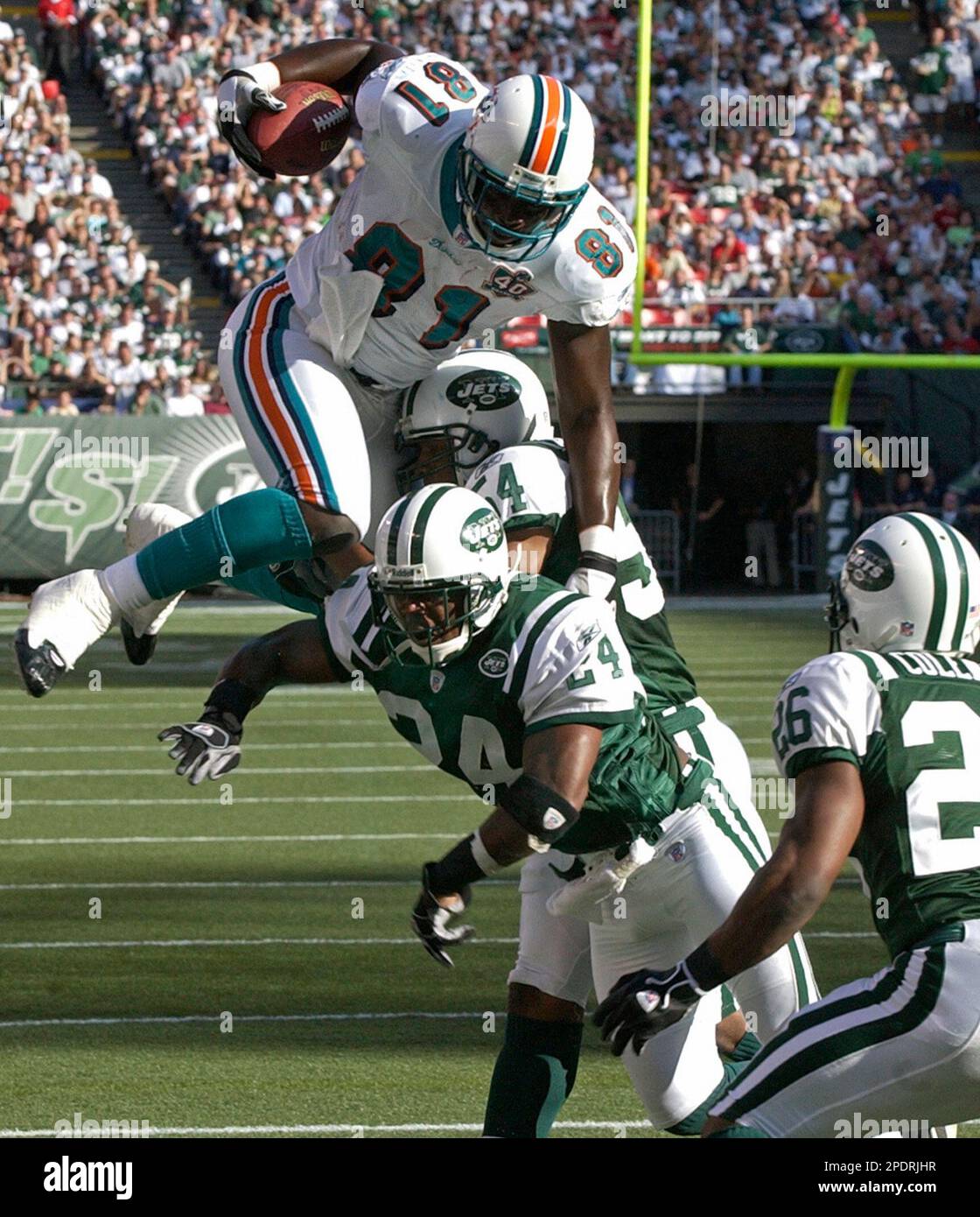 New York Jets linebacker Victor Hobson (54) and cornerback Ty Law (24 ...