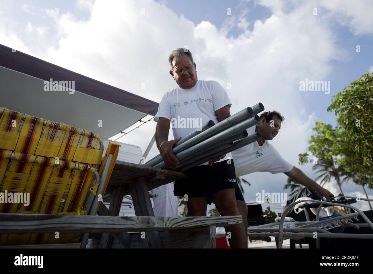 Raul Caballero and Albert Franquiz, right, start to pack away the ...
