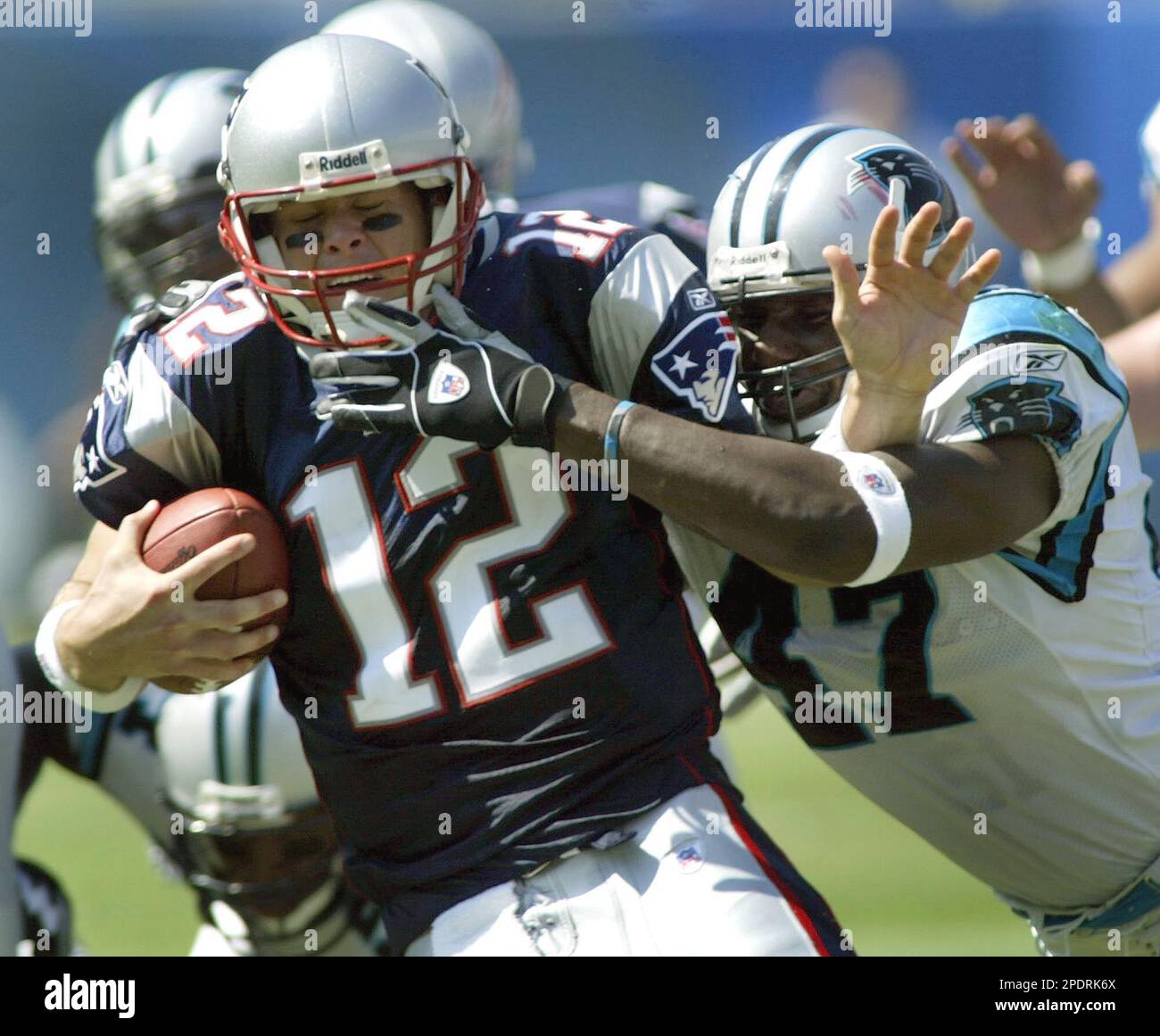 New England Patriots quarterback Tom Brady (12) is sacked by Carolina ...