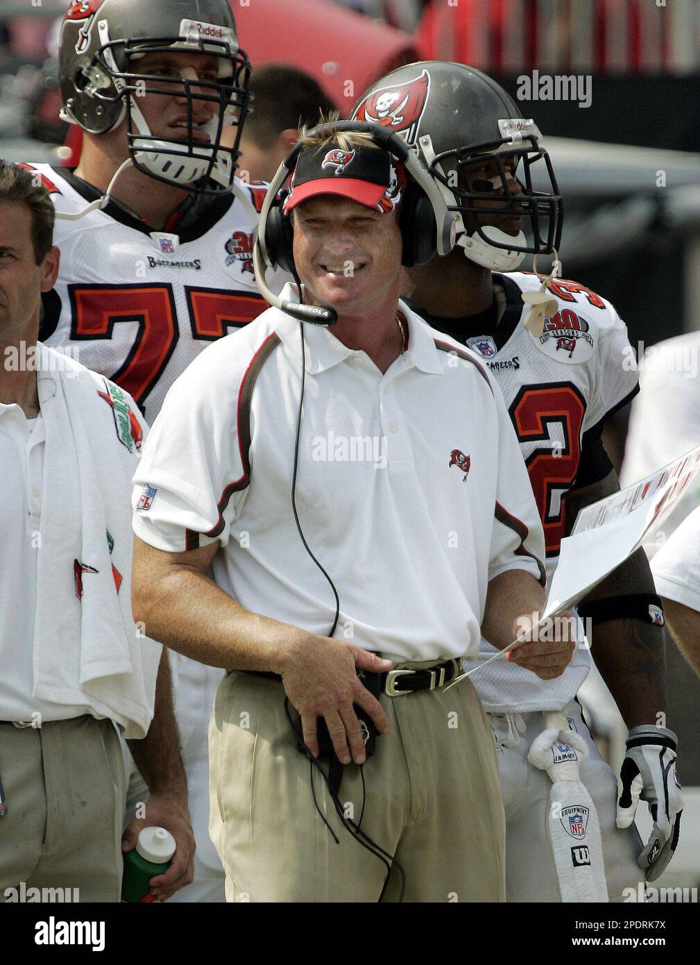 Tampa Bay Buccaneers coach Jon Gruden smiles as he stands with Jeb ...