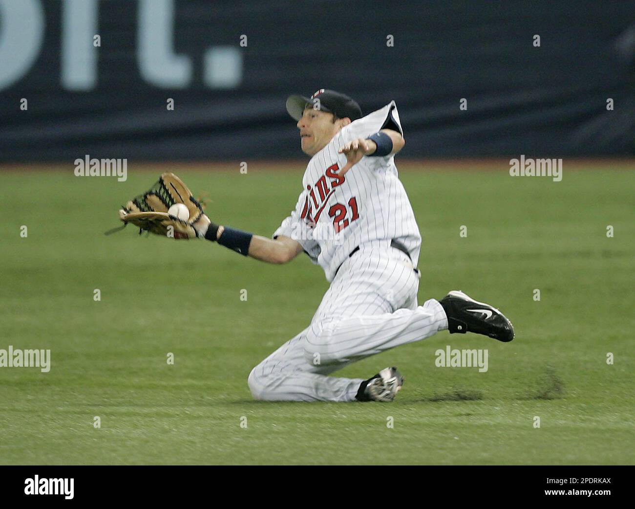Minnesota Twins right fielder Jason Tyner makes a sliding catch of a ...