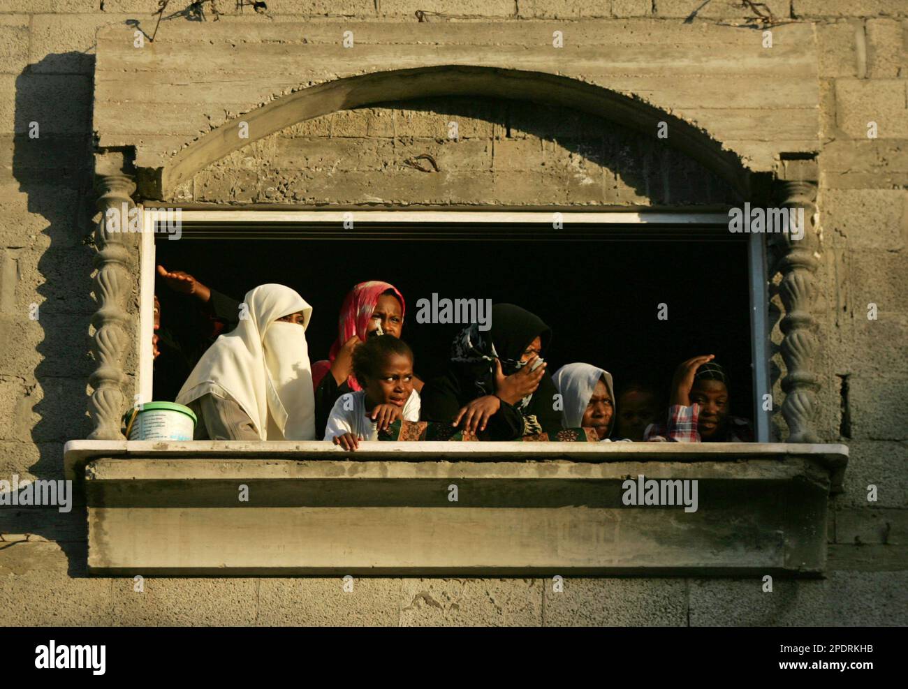 Palestinian women watch a Hamas parade in Gaza City, Sunday, Sept. 18 ...