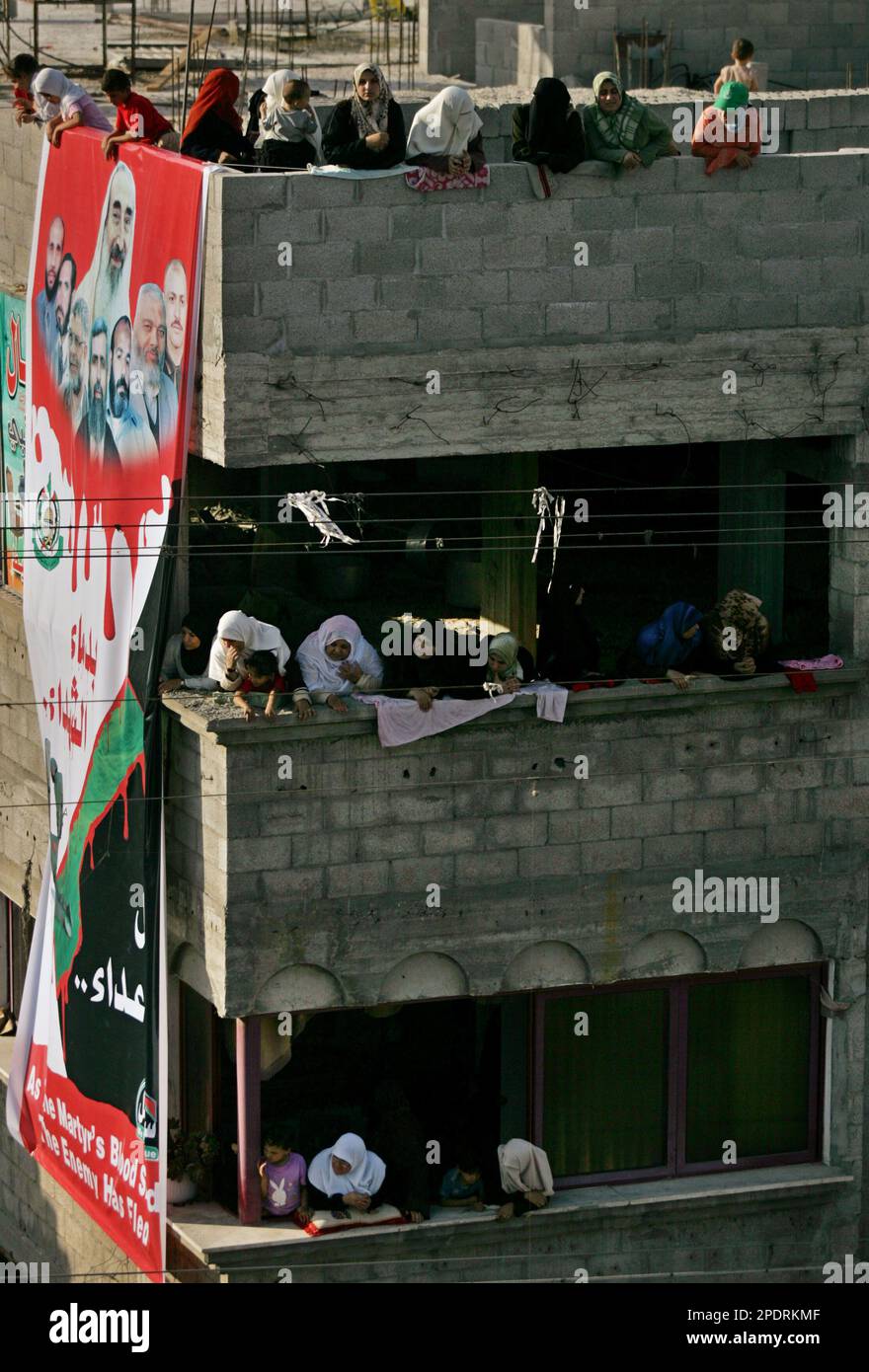 Palestinian women watch a Hamas parade in Gaza City, Sunday, Sept. 18 ...