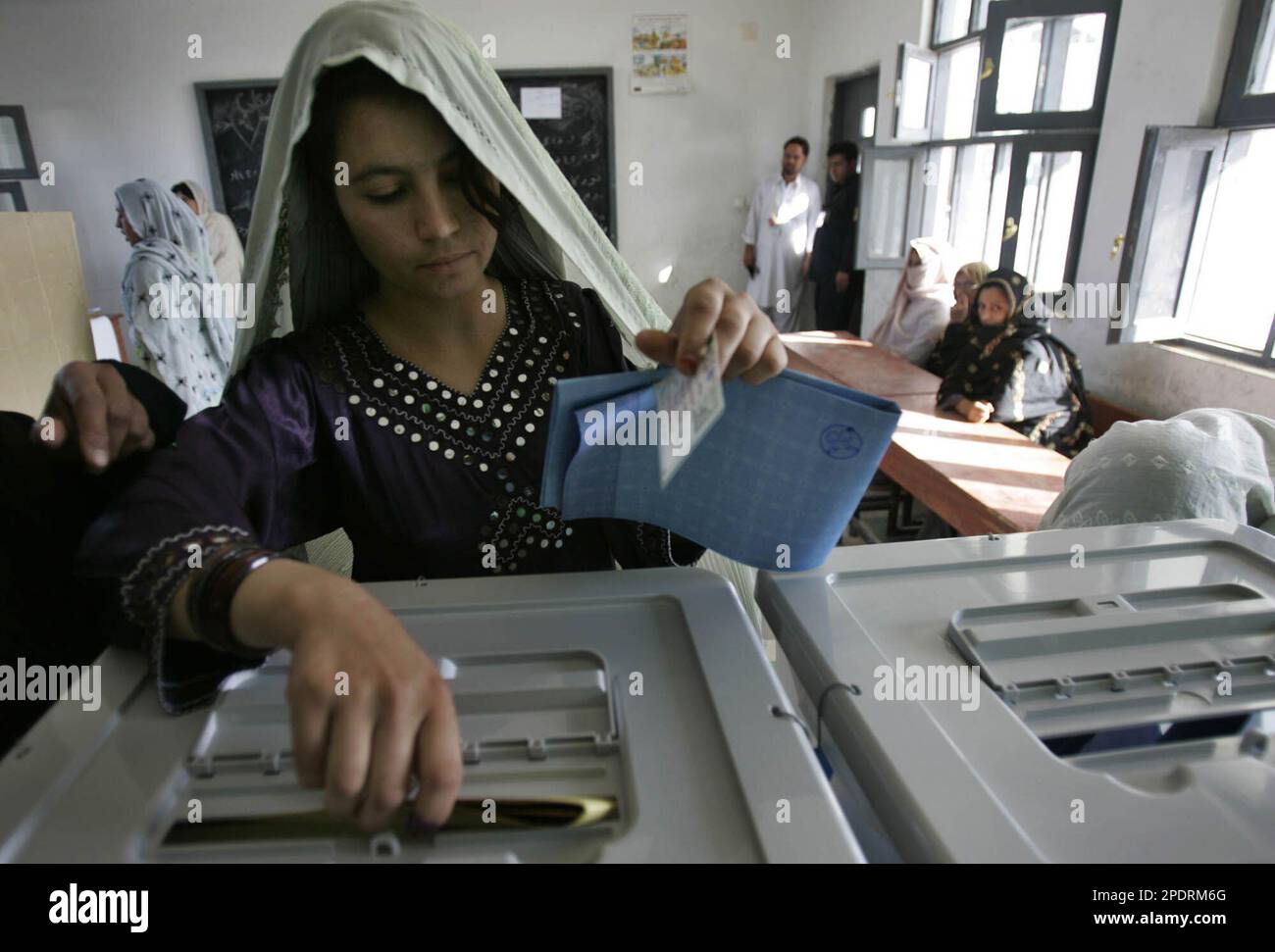 A woman casts her vote in Kandahar, Afghanistan, Sunday, Sept. 18, 2005 ...