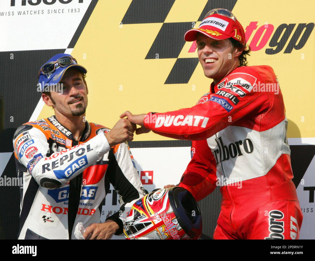 The winner of MotoGP race Loris Capirossi of Italy, right, celebrates ...