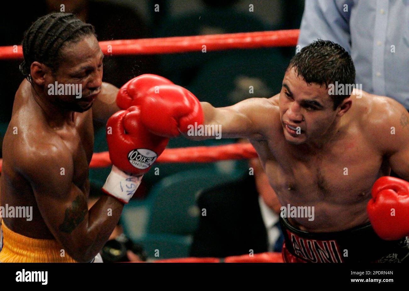 Leavander Johnson, left, takes a right from Jesus Chavez, right, in the 11th round during their ...