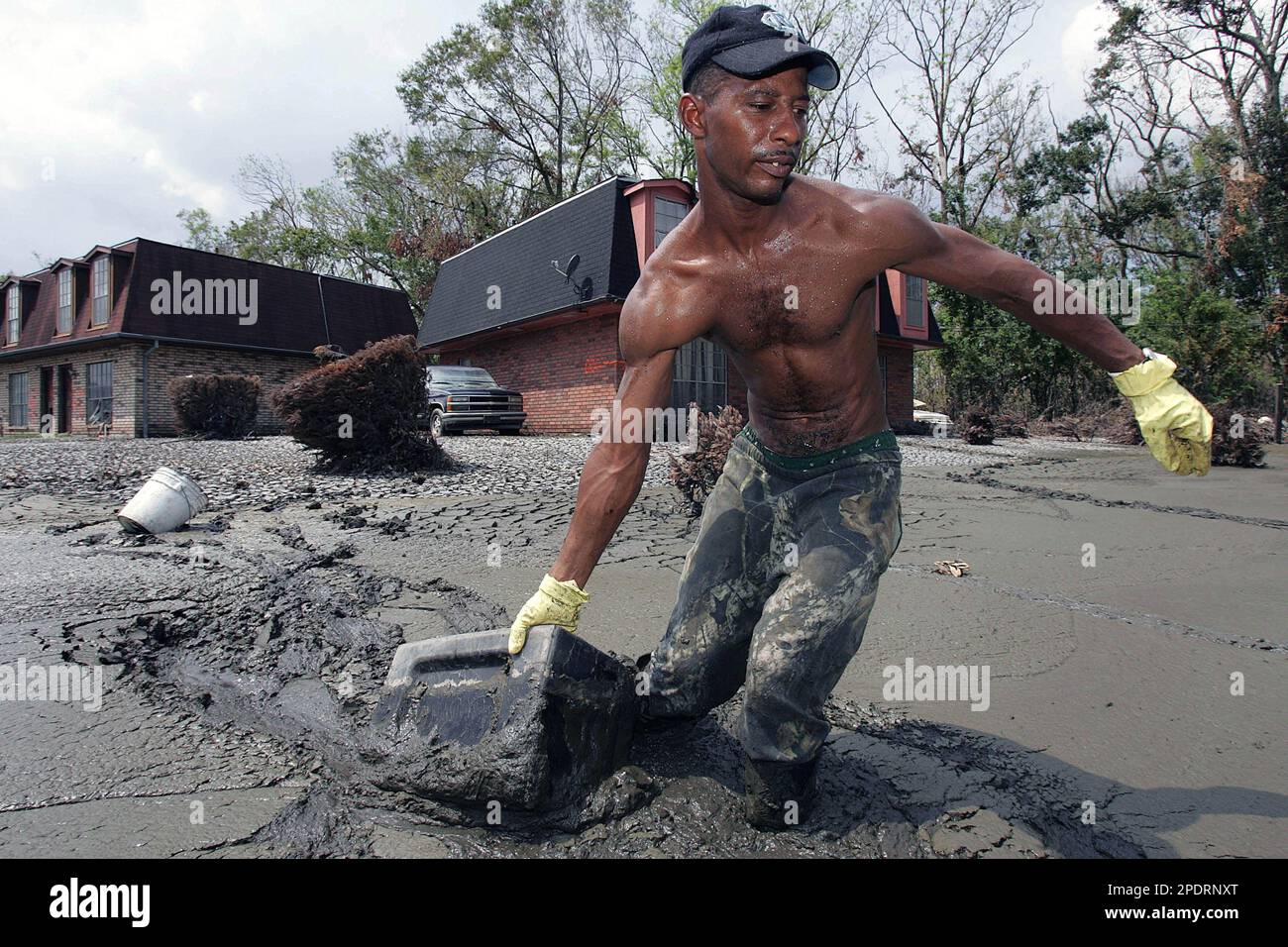 Reginald Banks pulls his uncle's tool box through foot high mud in ...