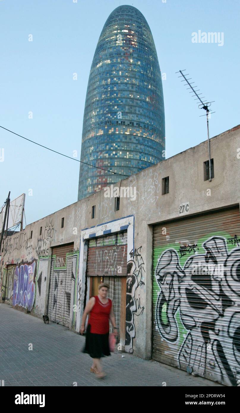 A women walks past the Agbar tower that was inaugurated by Spain's King ...