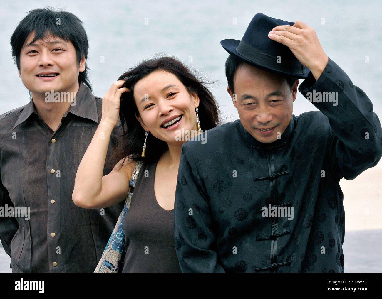 ** ADDS NAME OF FILM ** Actor Sun Hai Ying, right, waves with his hat as he poses actress Joan ...