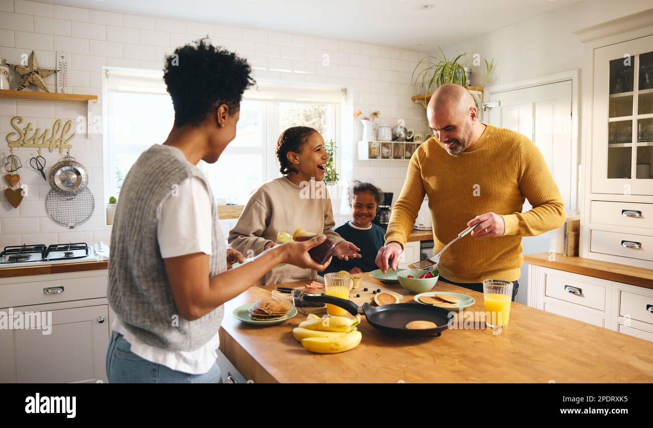 Family and boy with Down syndrome making pancakes for breakfast Stock ...