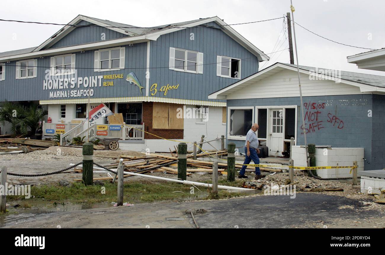 Clyde Cheezum walks past buildings destroyed by Hurricane Ophelia in ...