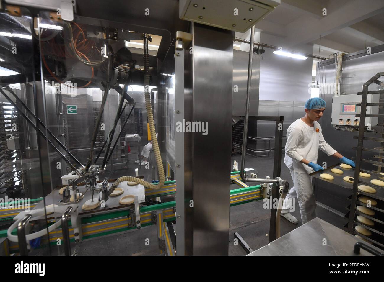 Moscow. An employee of the plant at the cheesecake machine at the ...