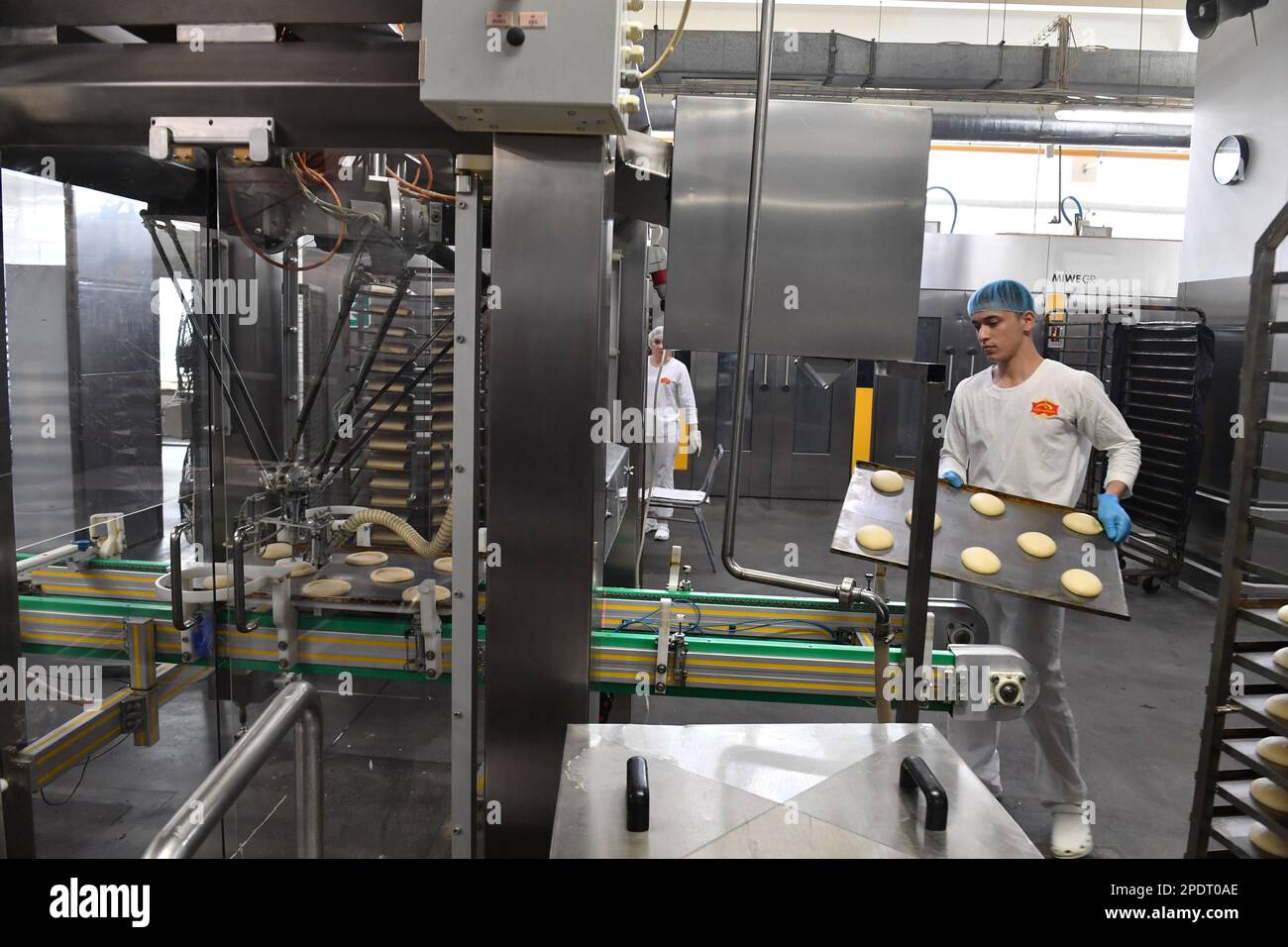 Moscow. An employee of the plant at the cheesecake machine at the ...