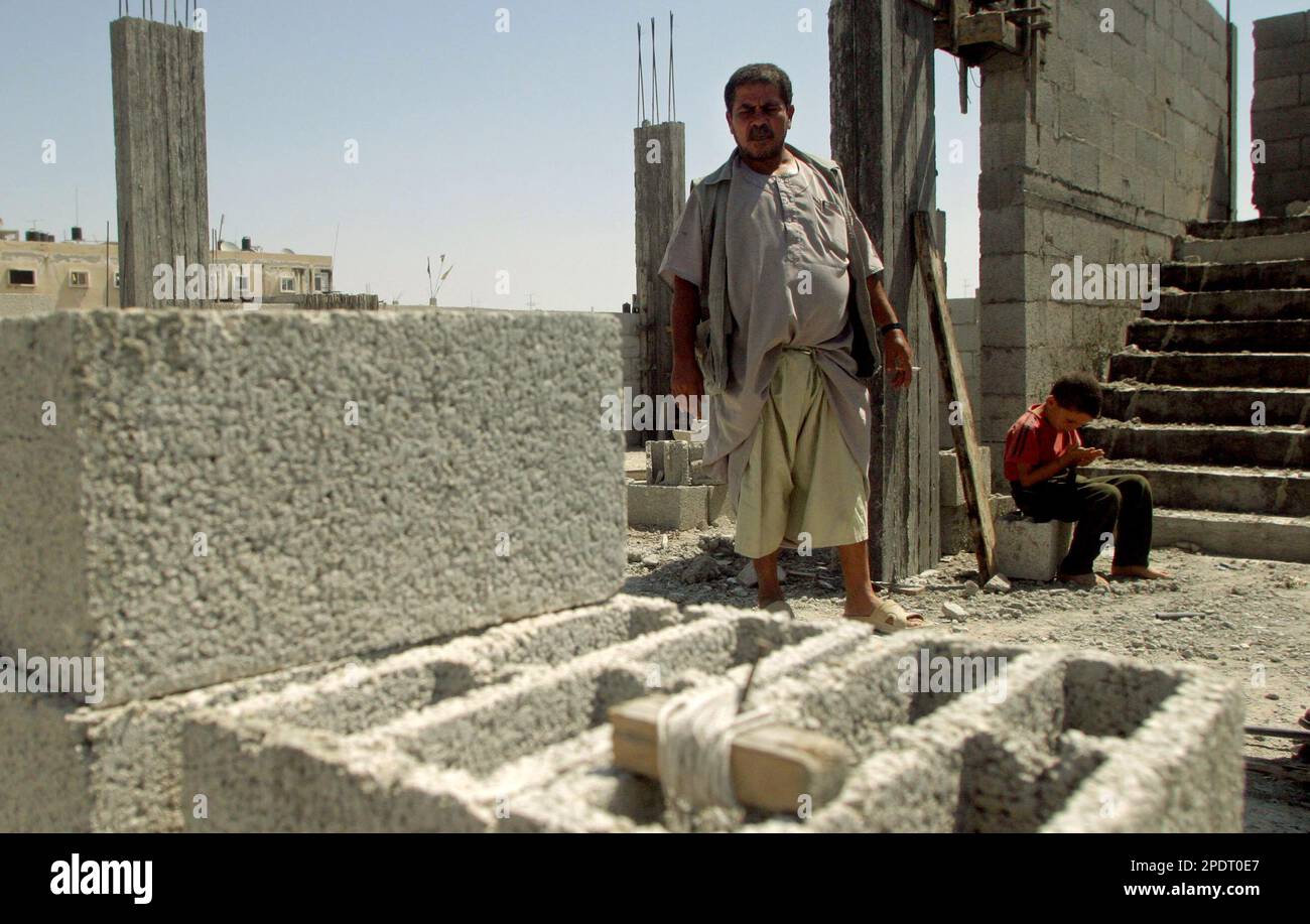 Palestinian Ismail Ashur stands in his partially built house in the ...
