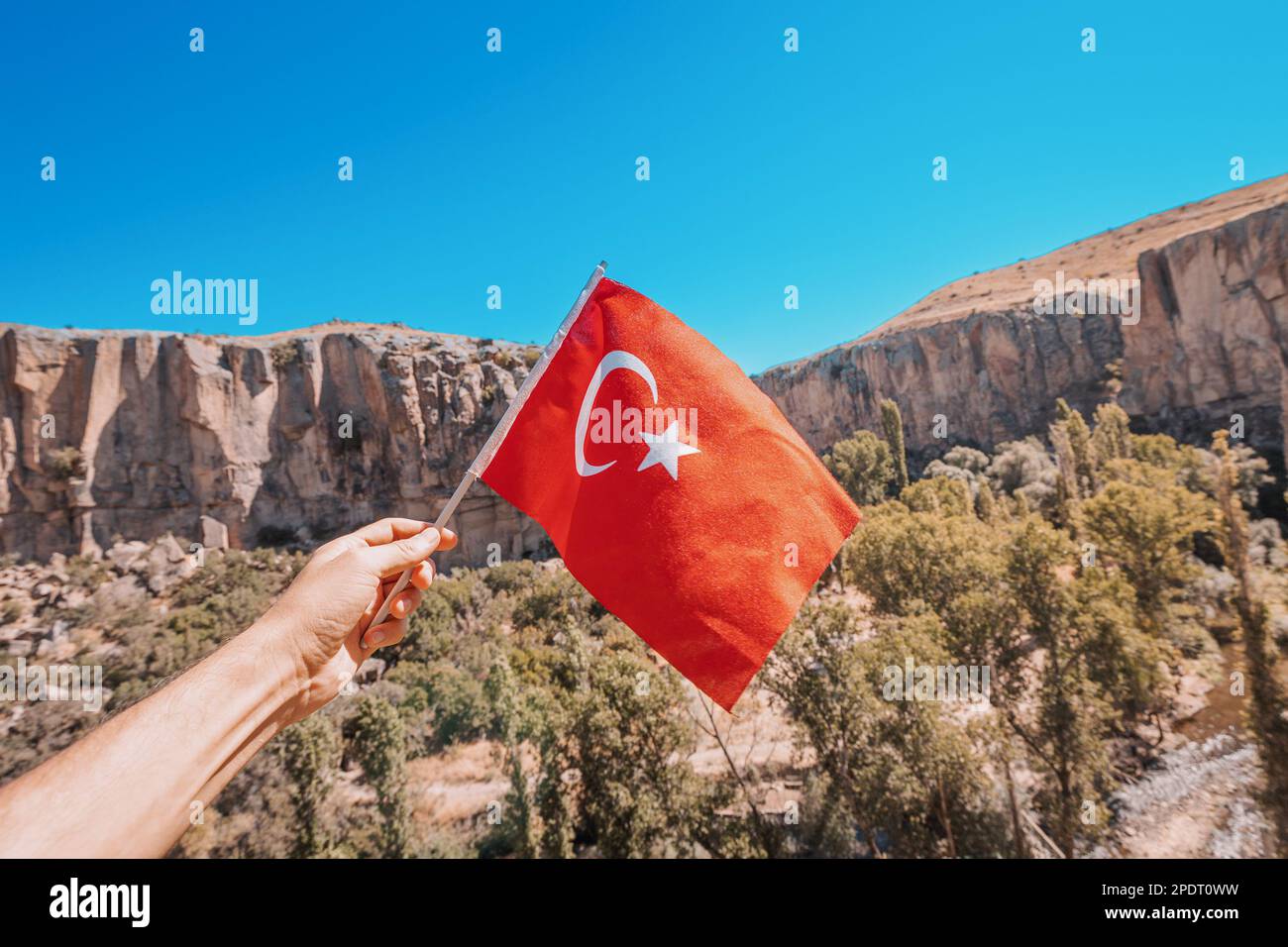 The national Turkish flag with famous Ihlara valley in Cappadocia in ...