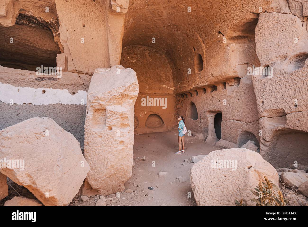 Tourist girl exploring ancient cave town in Ihlara valley, Cappadocia ...
