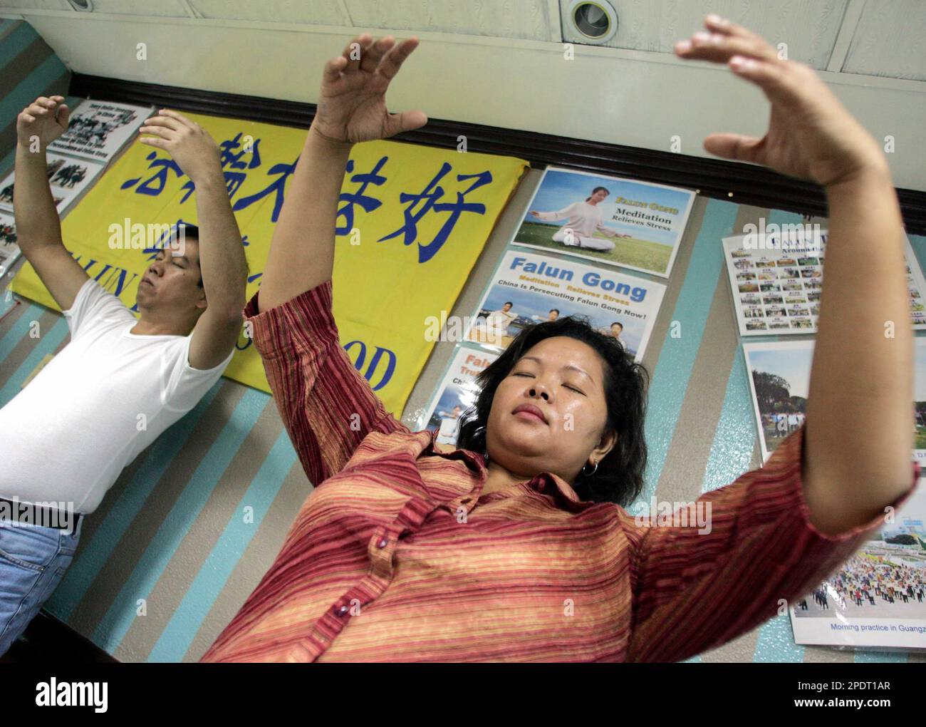 Filipino Falun Gong practitioner Bing Felipe, right, and Ronald Dela ...