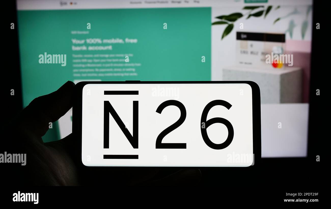 Person holding smartphone with logo of German financial services ...