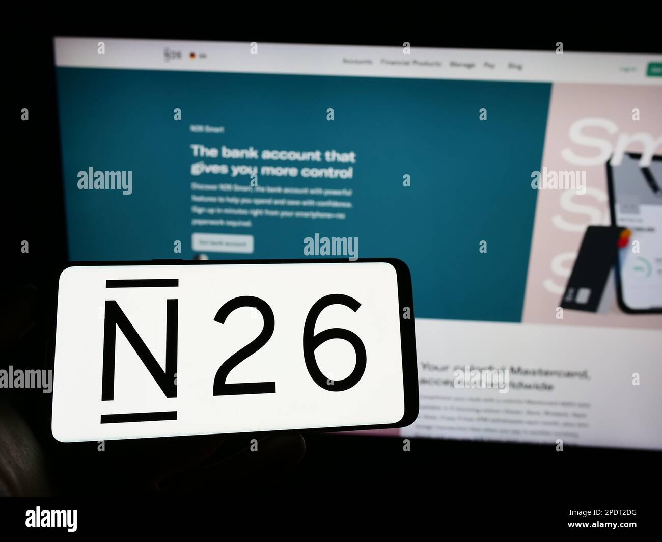 Person holding cellphone with logo of German financial services company ...