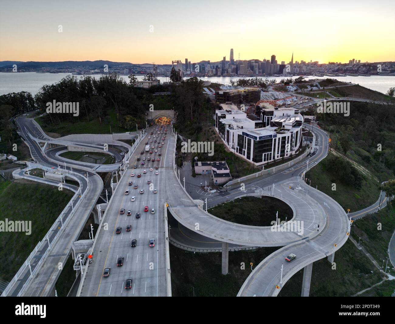 An aerial view of a multiple lane highway road with traffic at sunset ...