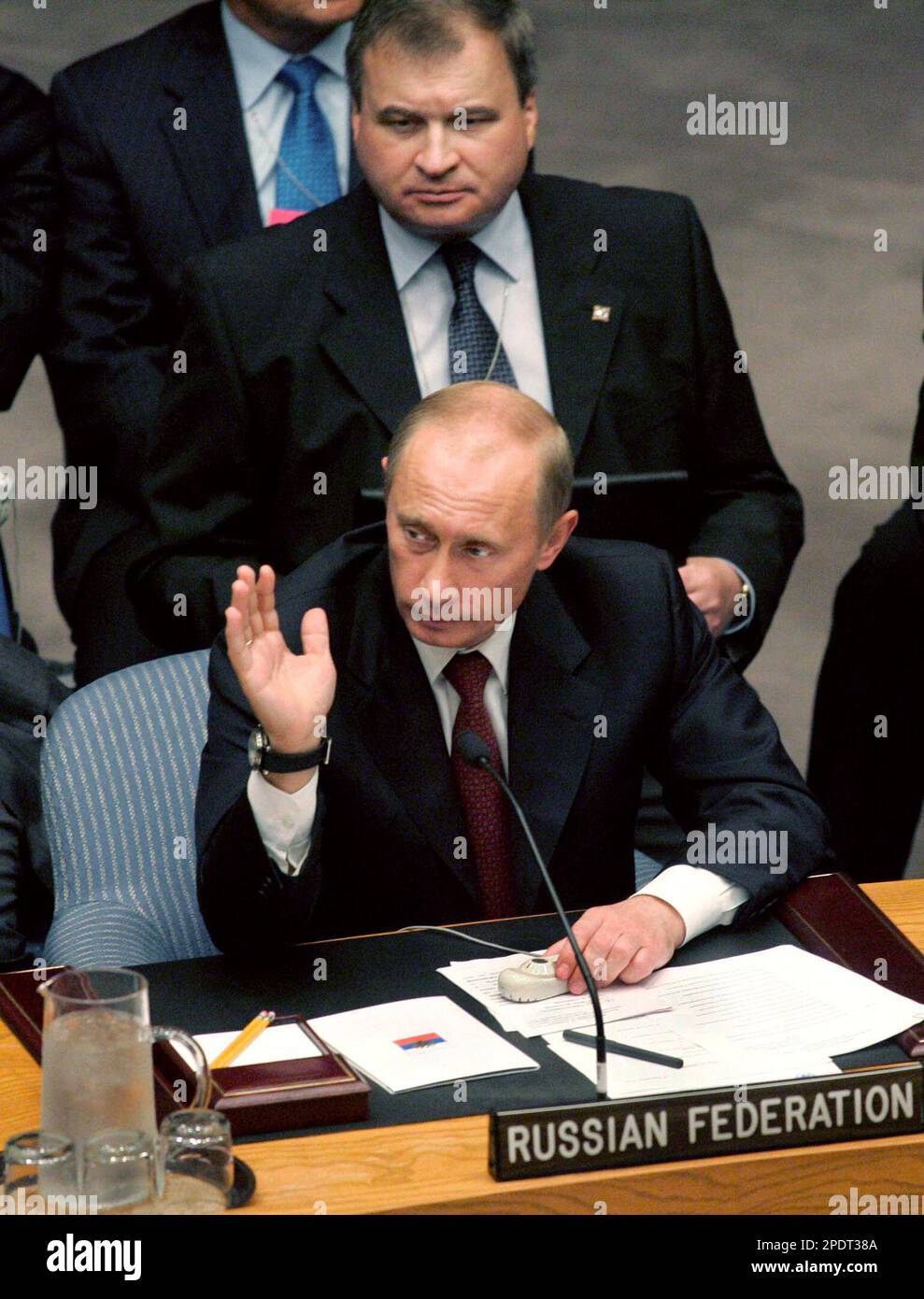 Russian President Vladimir Putin raises his hand for a vote during a ...