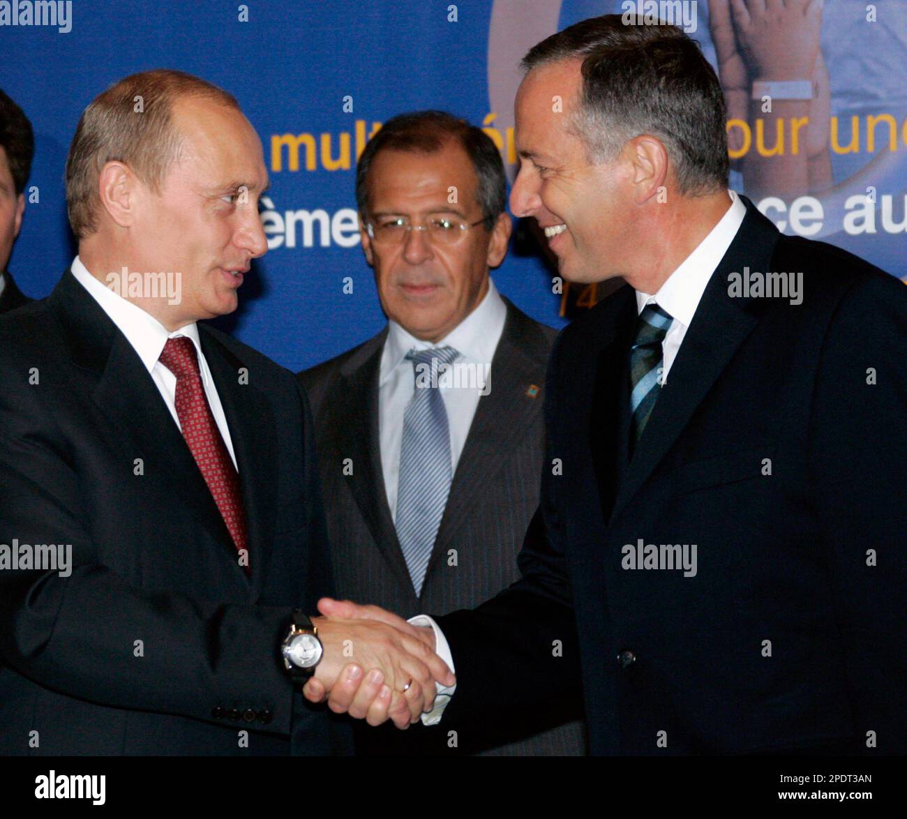 Russian President Vladimir Putin, left, shakes hands with an ...