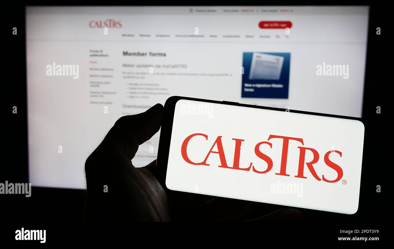 Person holding cellphone with logo of California State Teachers ...