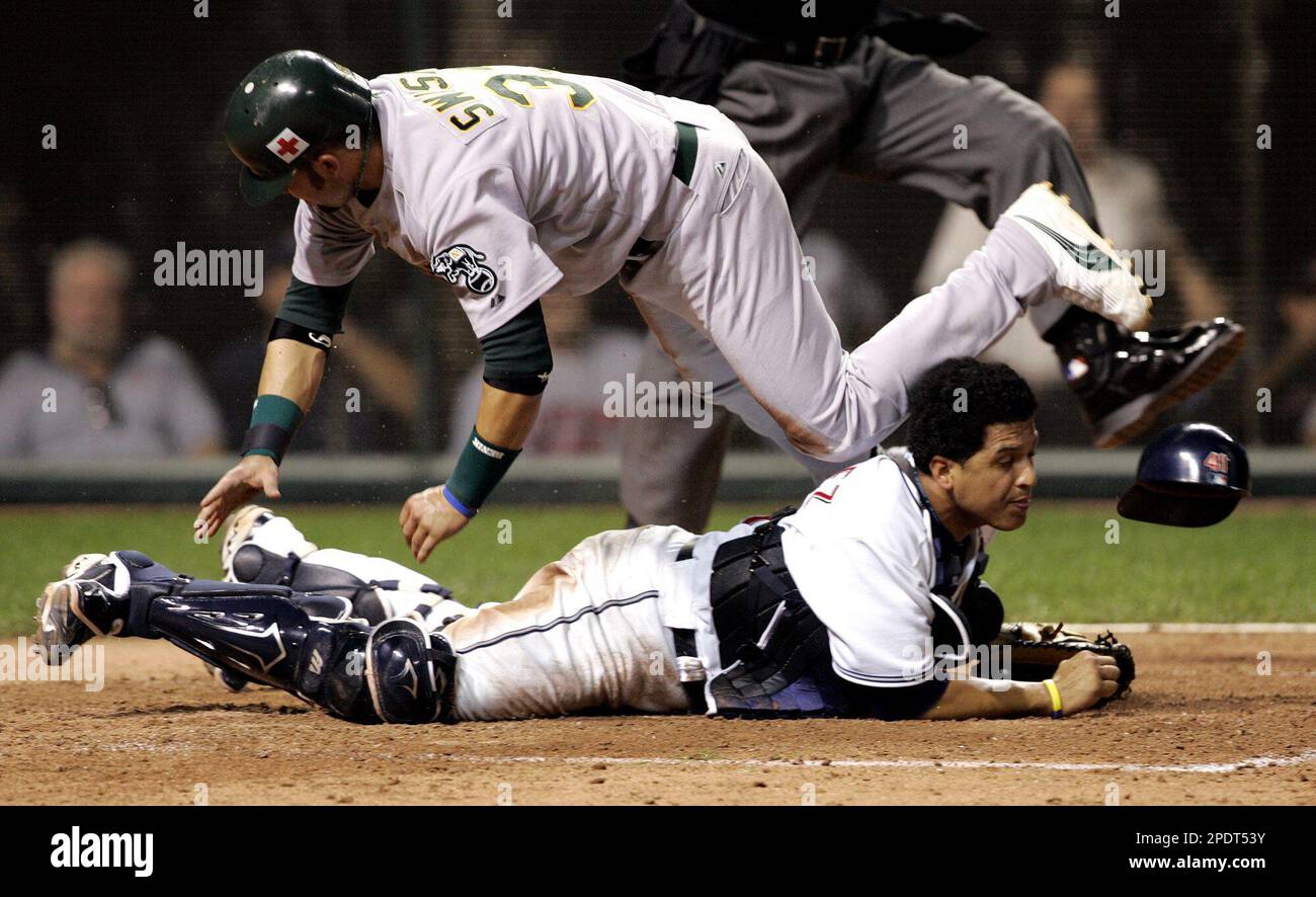 Oakland Athletics Nick Swisher jumps over Cleveland Indians catcher ...