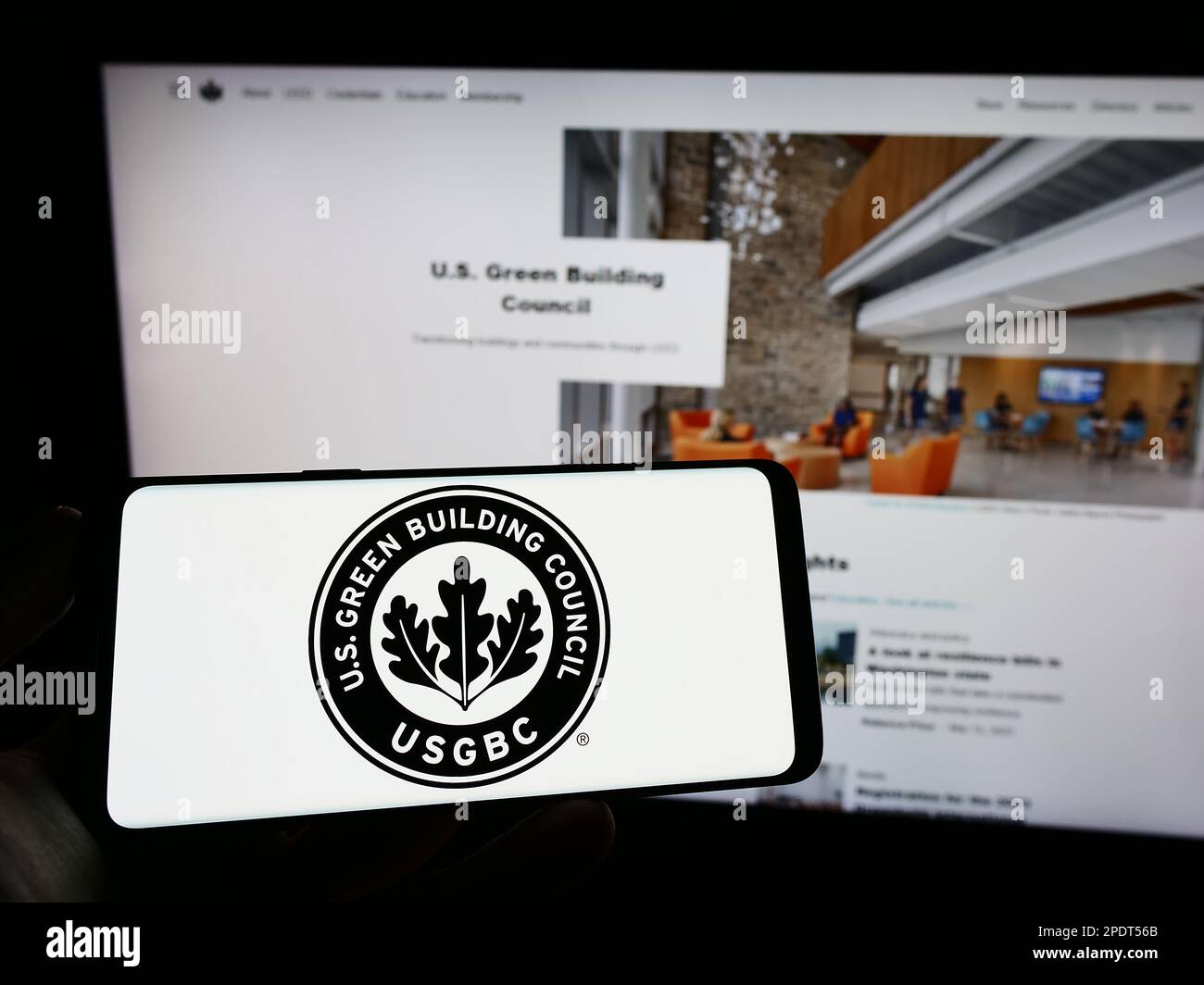 Person holding mobile phone with logo of US Green Building Council ...