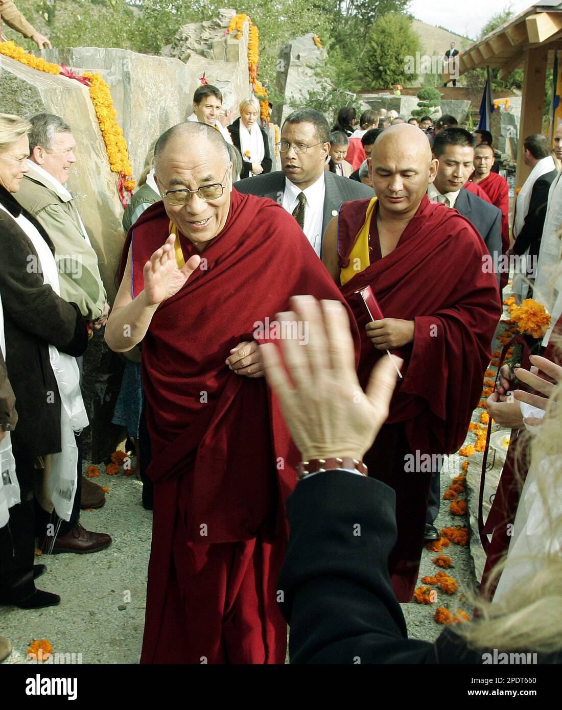 The Dalai Lama waves to a follower prior to a blessing ceremony for the ...