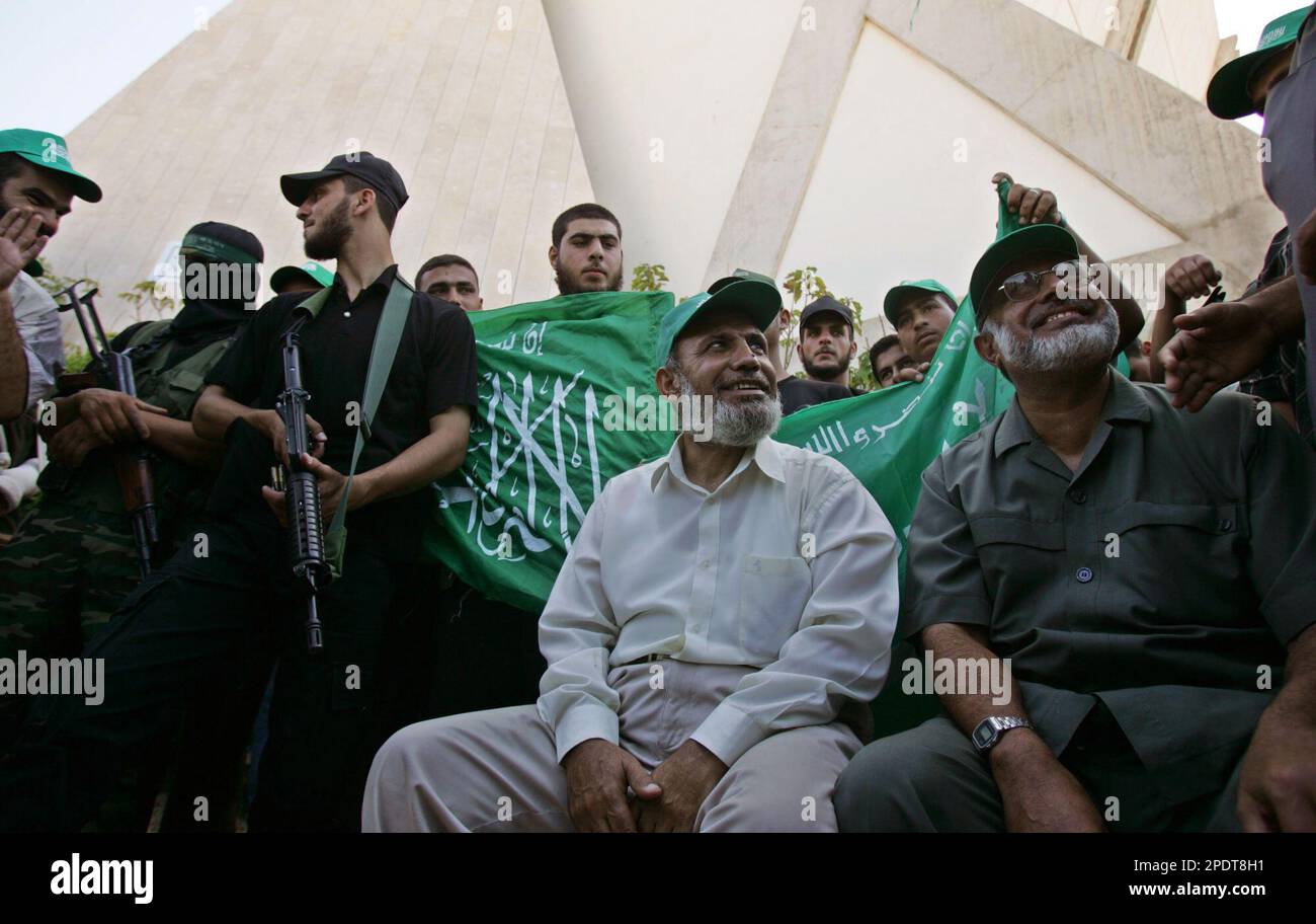 Hamas leader Mahmoud Zahar, second right, sits outside the Jewish ...