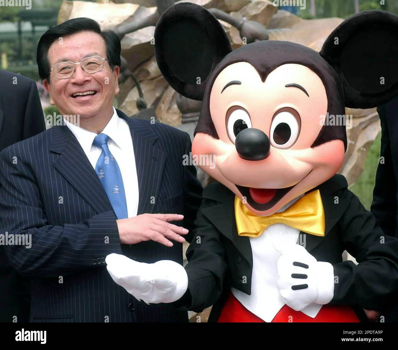 China's Vice President Zeng Qinghong poses with Mickey Mouse at the ...