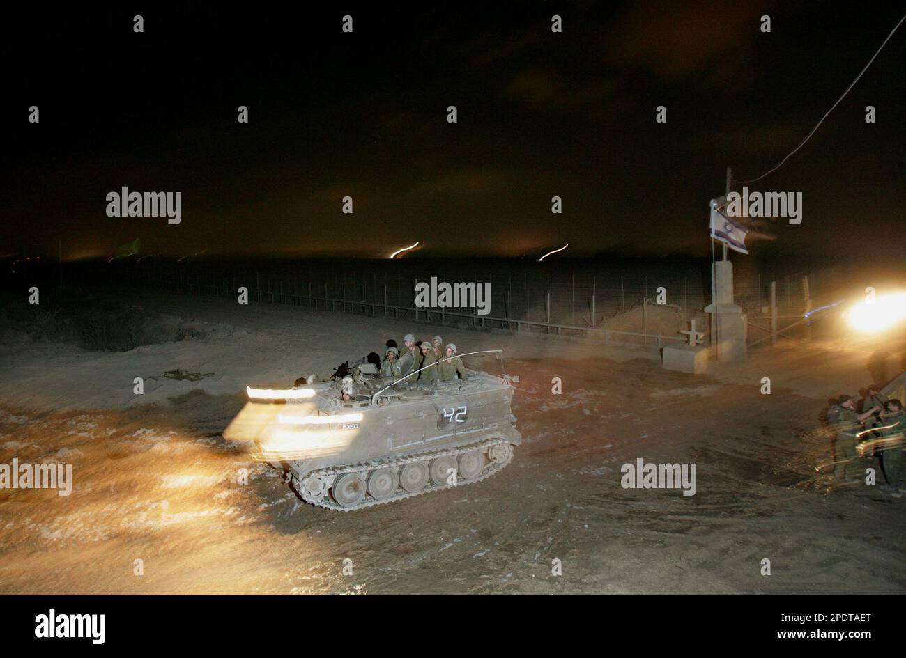 An Israeli army armored vehicle leaves the Gaza Strip through the Karni ...